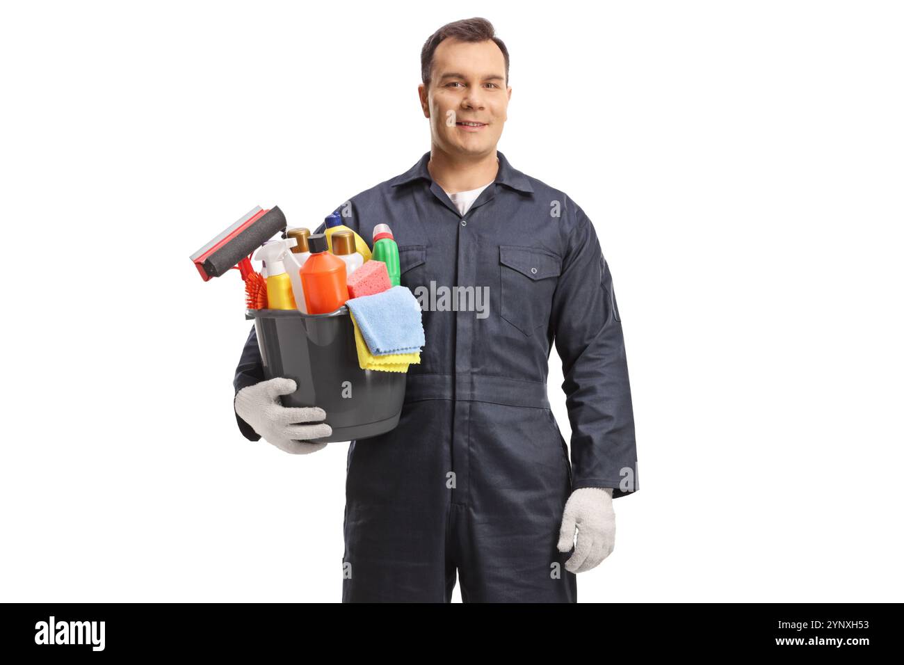 Male cleaner in a uniform posing with a bucket of cleaning supplies ...