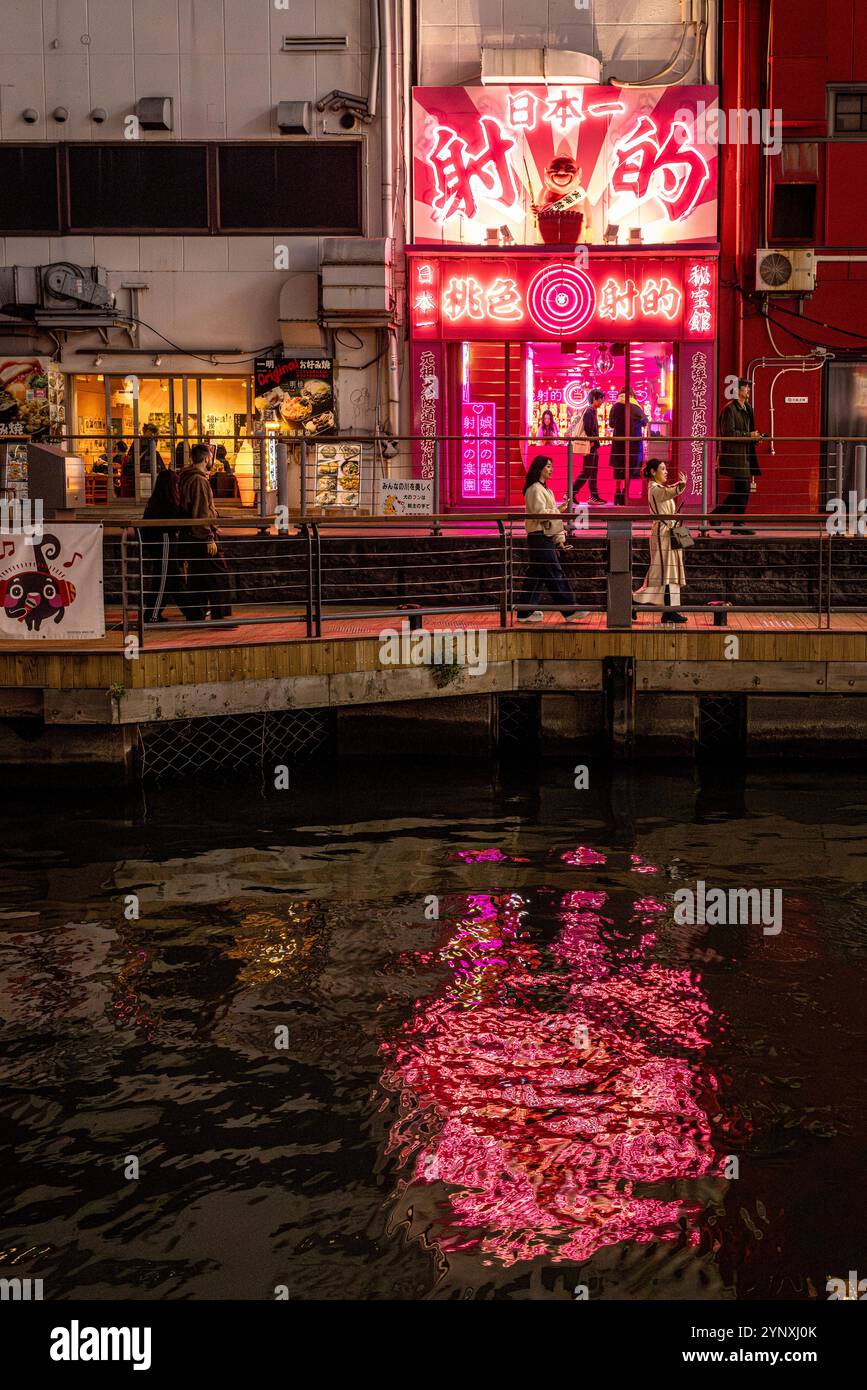 Dotonbori canal reflecting vibrant neon lights of osaka at dusk Stock ...