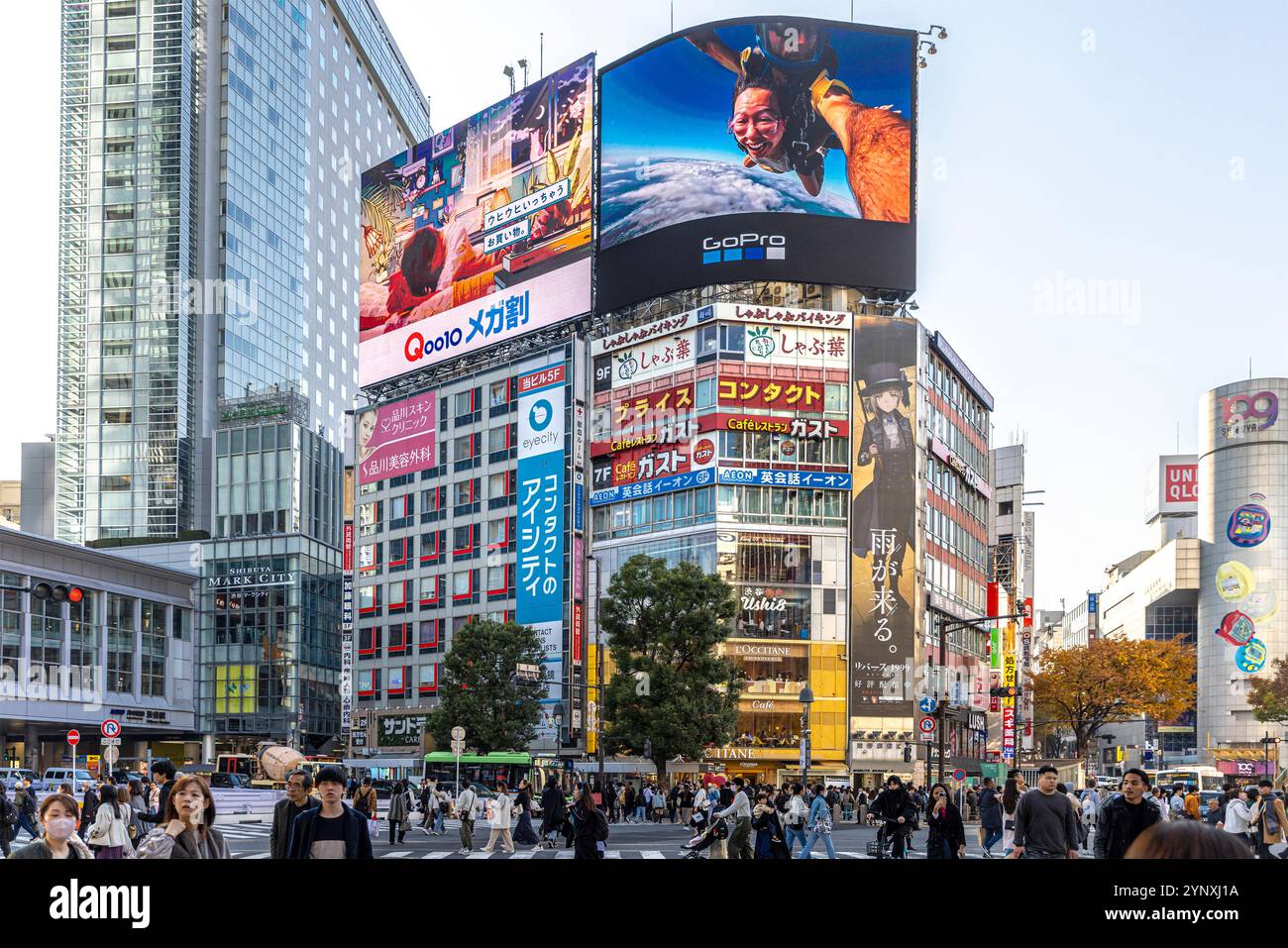 Shibuya crossing crowded with people and large advertising screens ...