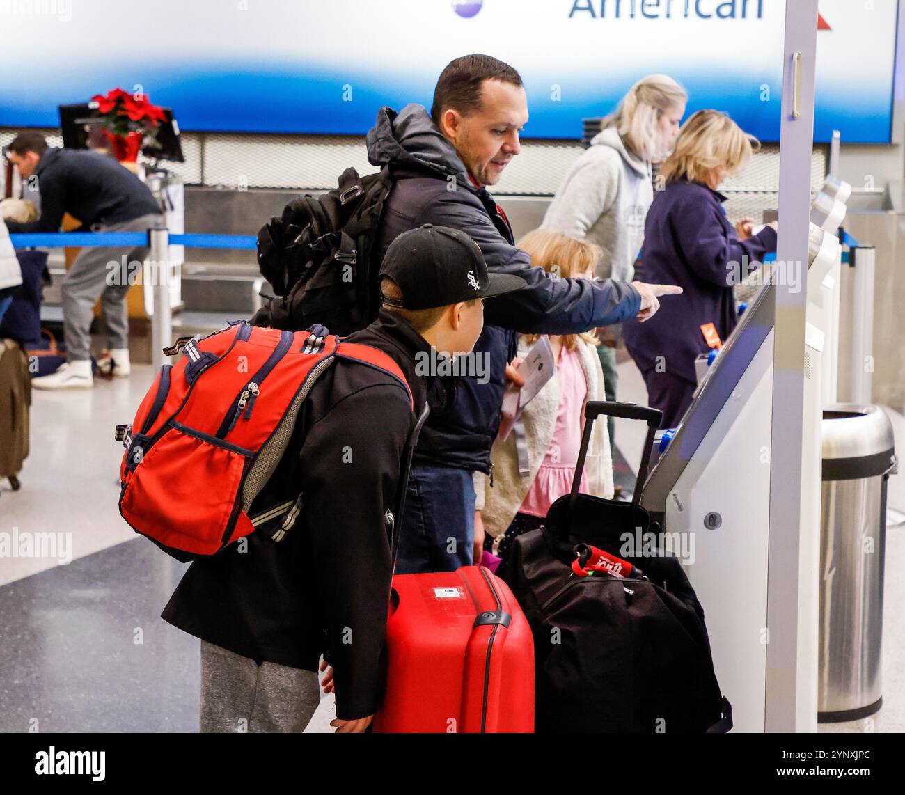 Chicago, United States. 27th Nov, 2024. People check in for flights the ...