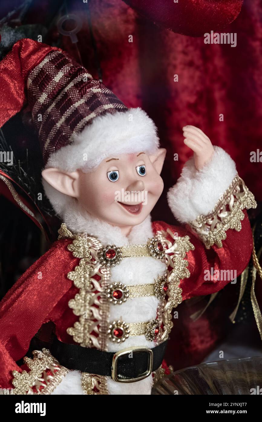 Santa Claus elf toy with red costume Stock Photo - Alamy