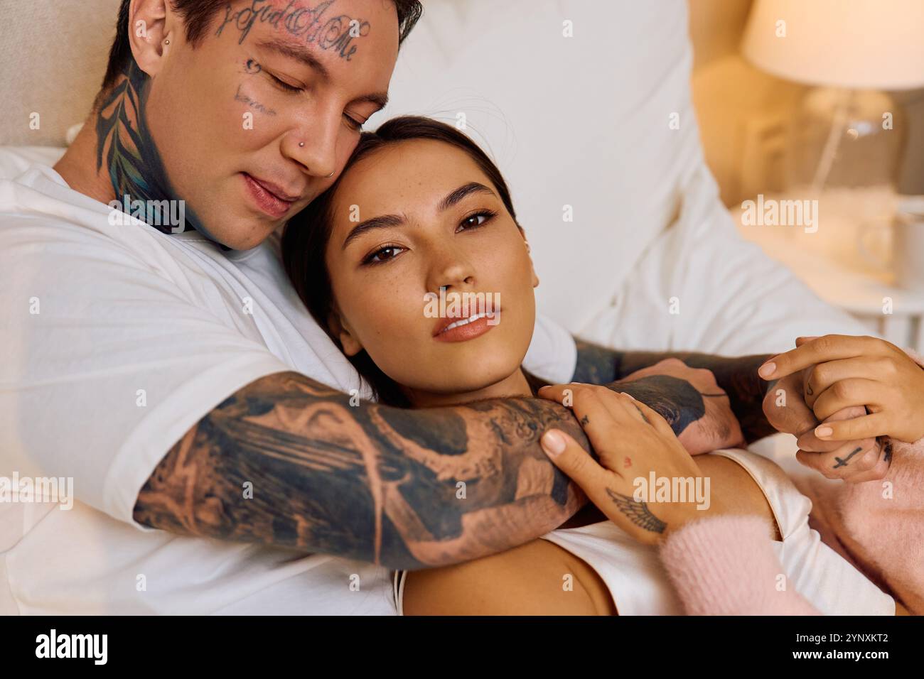 A loving couple embraces on a couch, radiating affection and connection ...