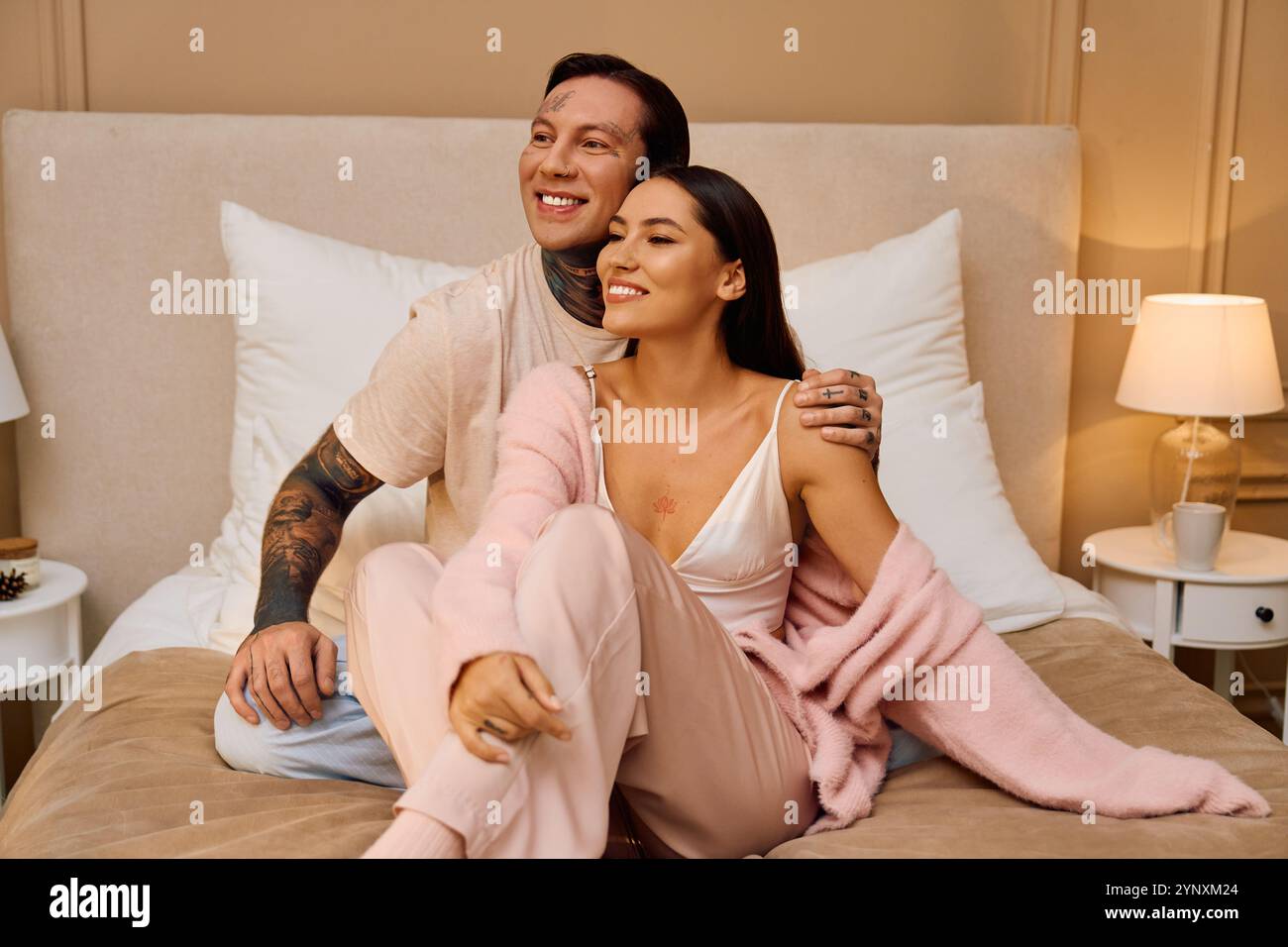 In a serene bedroom, a loving couple shares joy and connection while ...