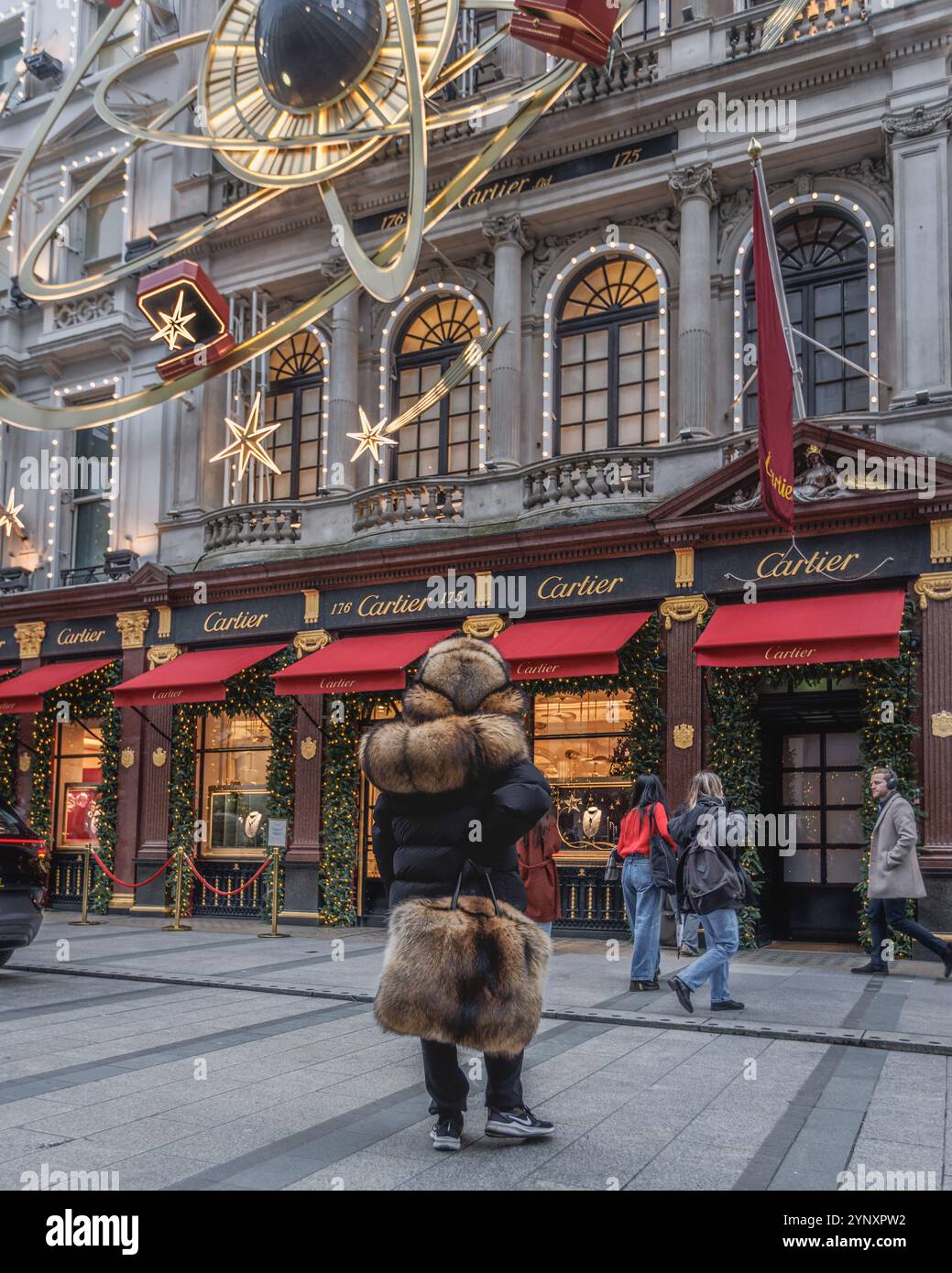 A shopper in fur outside the famous Cartier store in the heart of ...