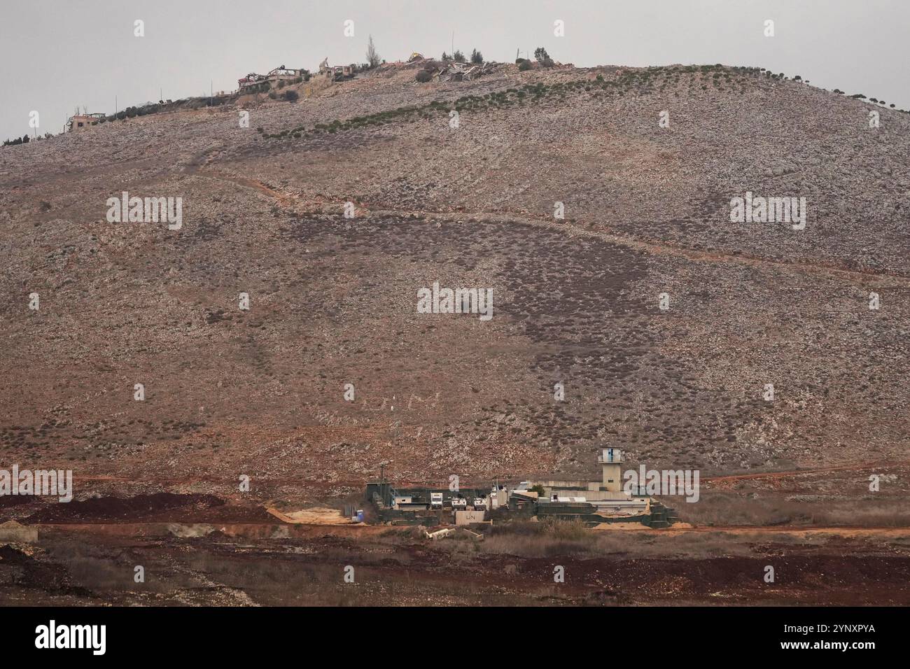 A UN soldier stands on the top of a tower at a base of the United ...