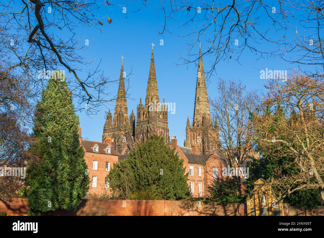 Three spires of Lichfield Cathedral towering over buildings Stock Photo ...