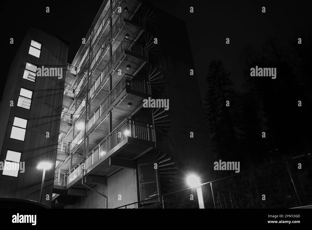 Dark apartment building lit window Black and White Stock Photos ...