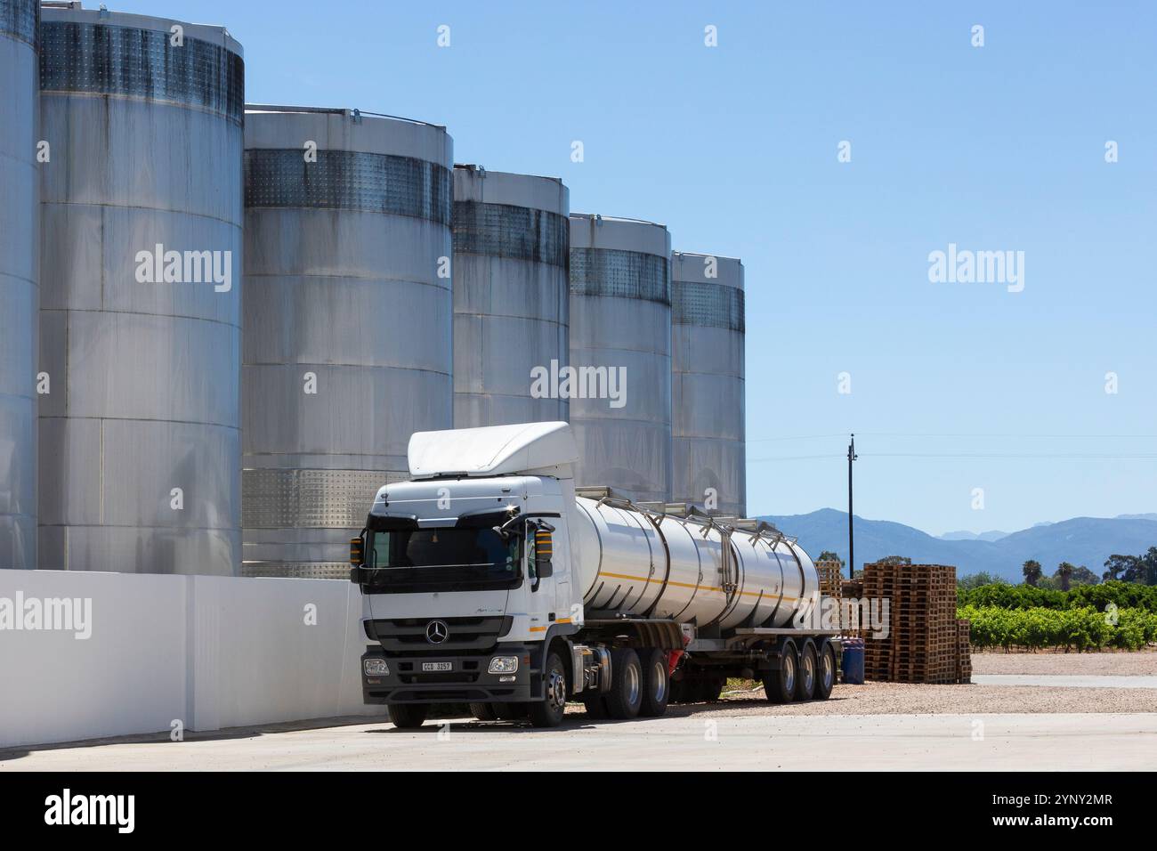 Wine tanker for transporting wine next to stainless steel fermentation ...