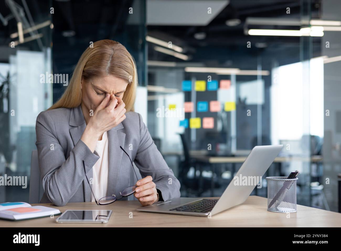 Mature woman businesswoman experiencing stress at office desk with ...
