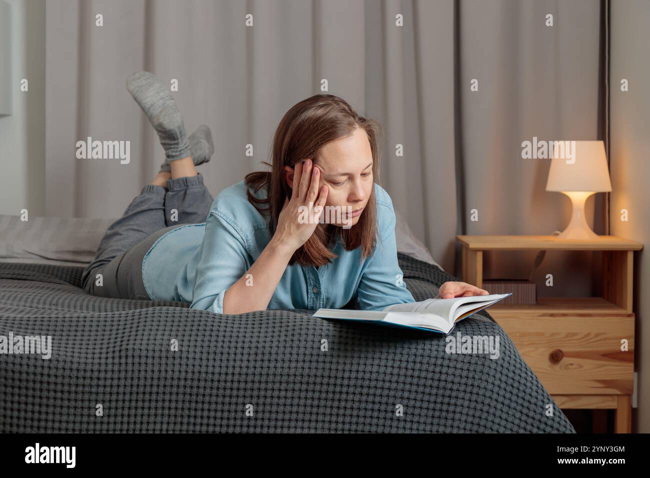 Concentration study young woman lying hi-res stock photography and ...