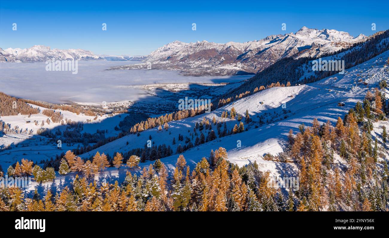 Aerial view of Champsaur Valley in Autumn with snow covered slopes ...