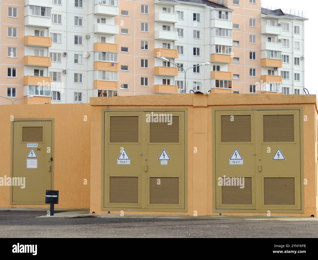 distribution transformer booth with several doors with signs about the ...