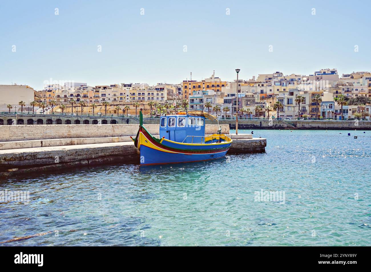 Traditional Maltese fishing boat luzzu docked in a coastal ...