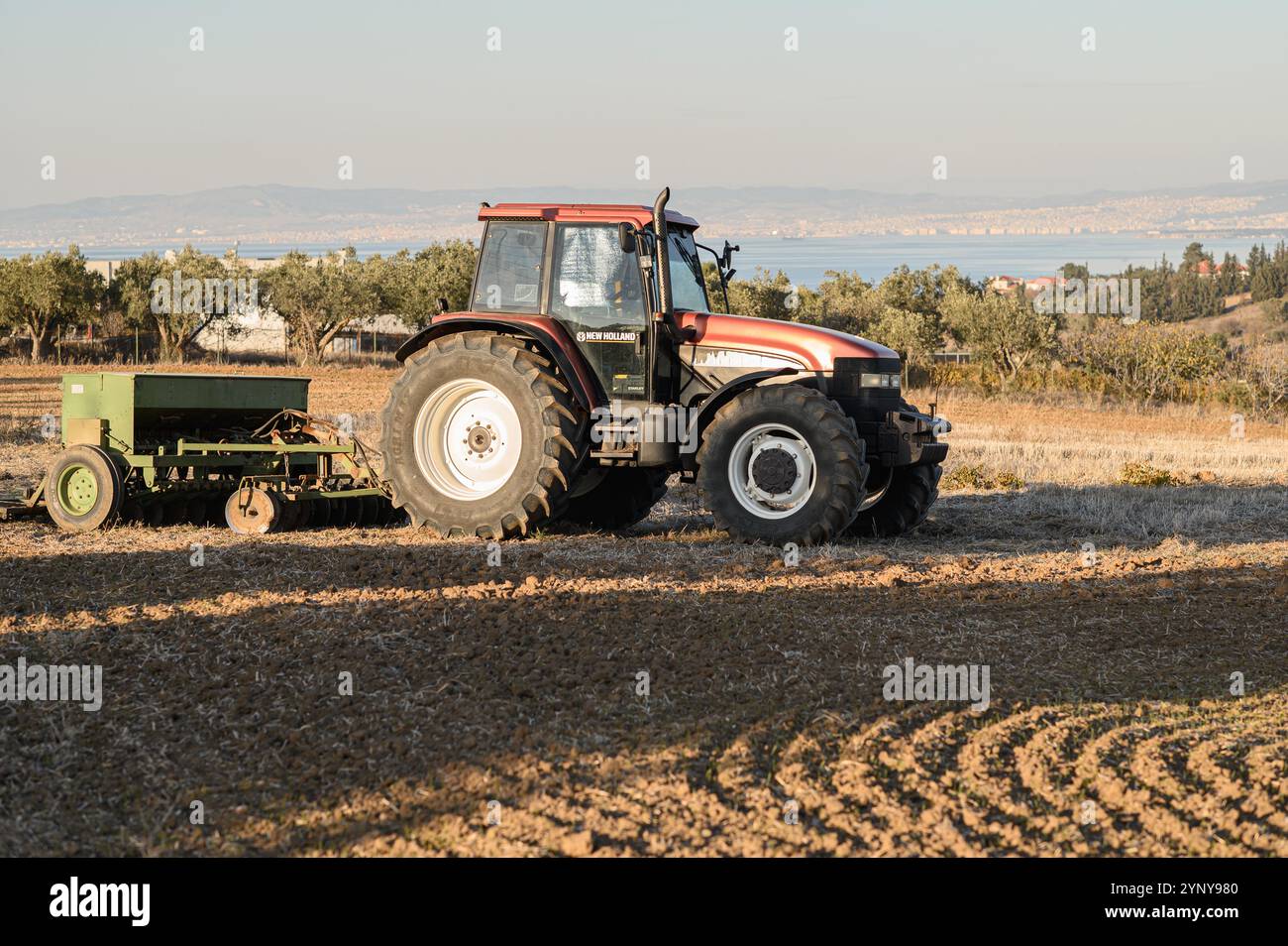 tractor on the field cultivating Stock Photo - Alamy