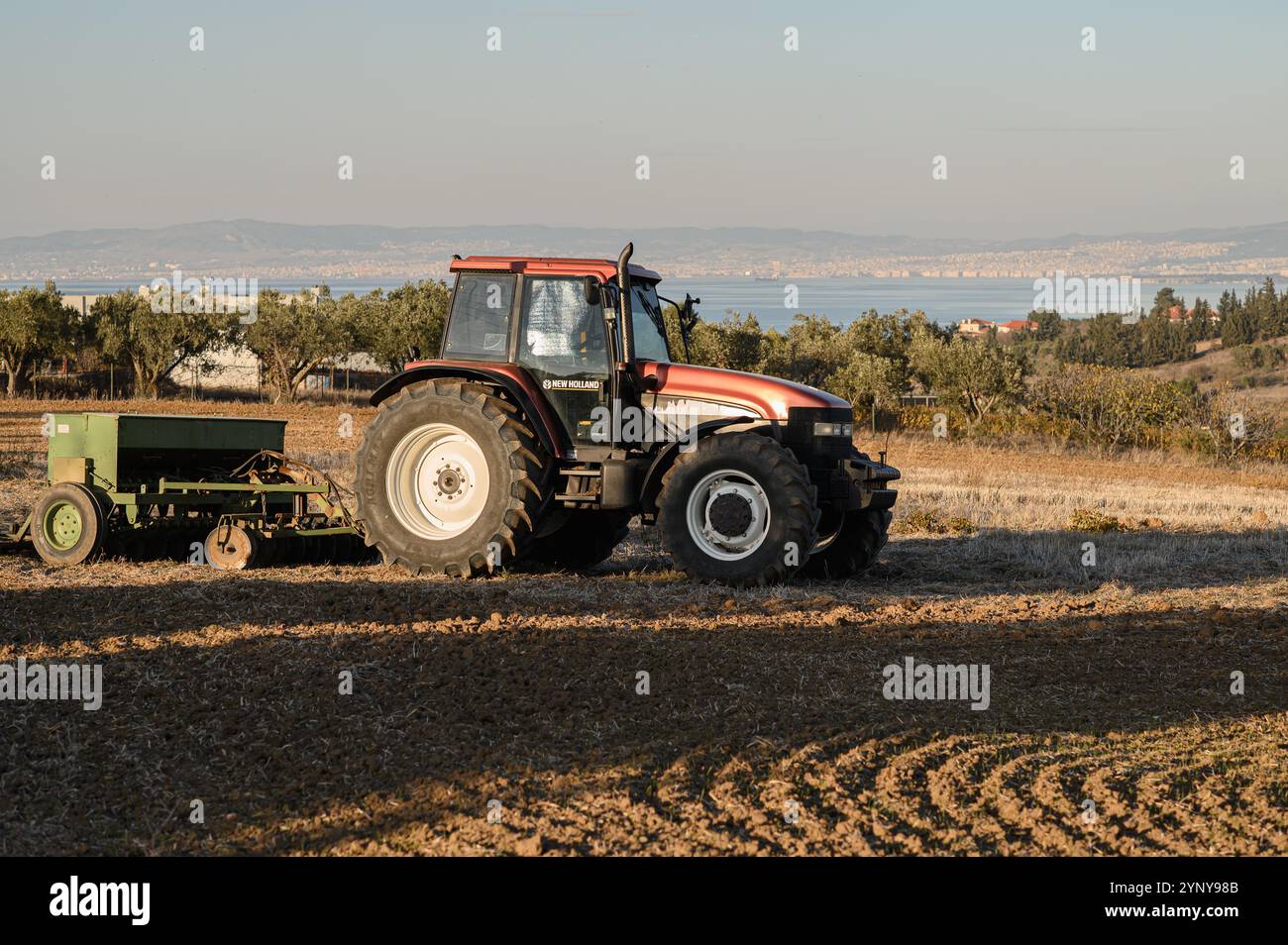tractor on the field cultivating Stock Photo - Alamy