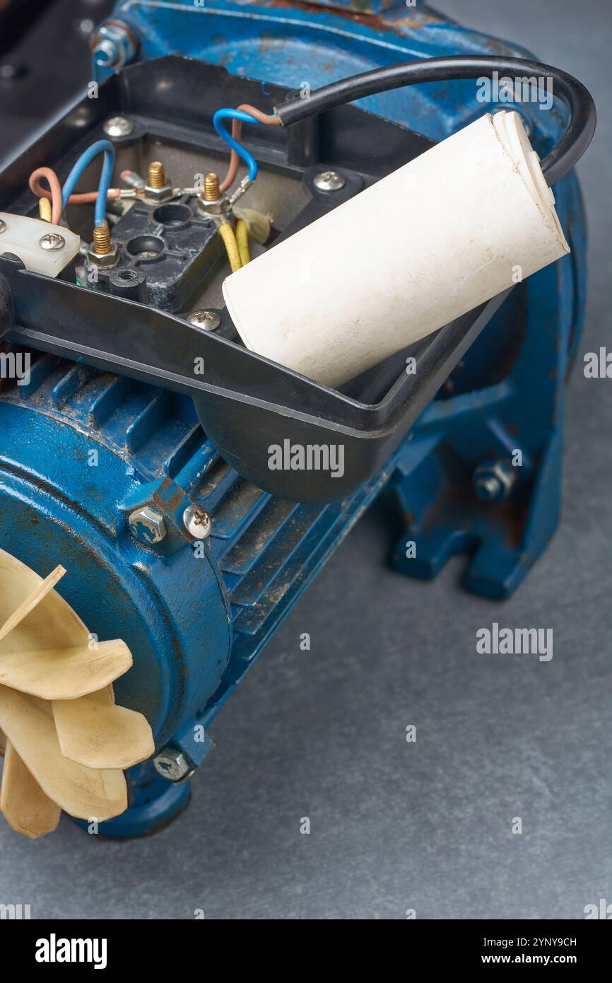 exposed capacitor and electrical wiring of disassembled water pump ...