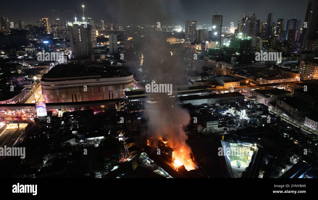 Manila, Philippines. 28th April 2024. In an aerial view, a fire that ...