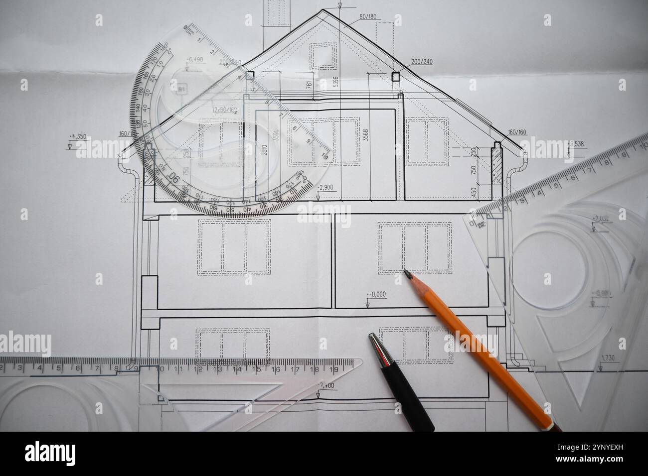 Architectural project being drawn with ruler, protractor and pencil on ...