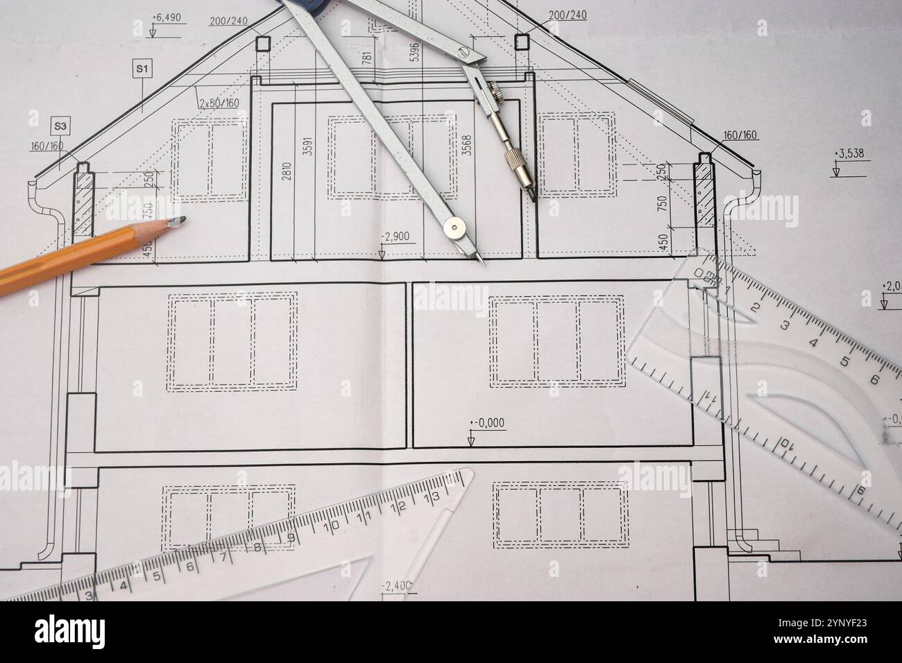Architectural project being designed with compass, ruler and pencil ...