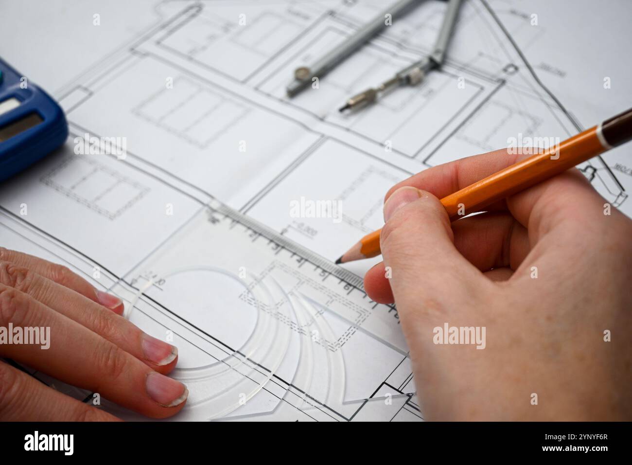 Architect drawing architectural project using compass, ruler ...