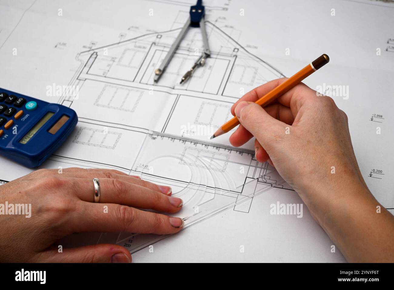Architect drawing architectural project using compass, ruler ...