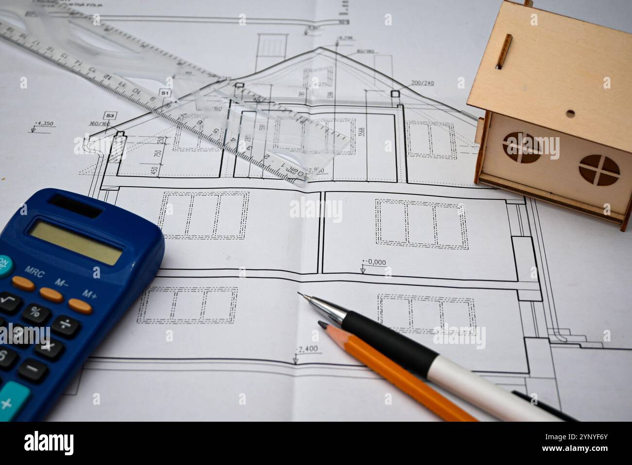 Architectural project of a house with construction tools lying on ...