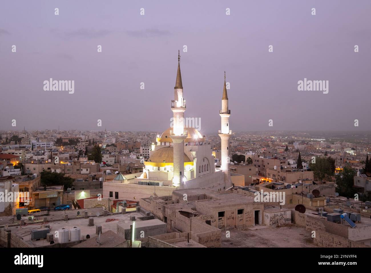 Mosque of jesus christ illuminating Madaba at sunset in Jordan Stock ...
