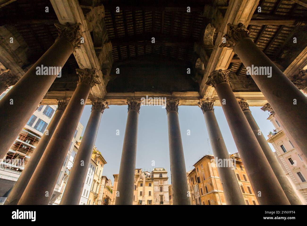 The majestic columns of the Pantheon frame the charming buildings of ...