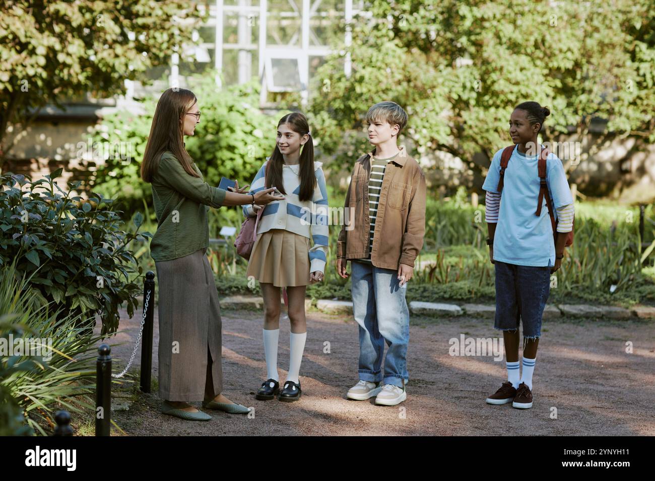 Tour Guide Greeting Kids In Botanical Garden Stock Photo - Alamy