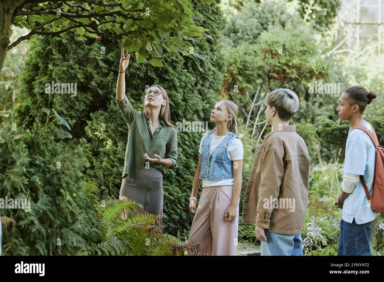 Teacher Of Biology Showing Trees To Her Students During Outdoor Lesson ...