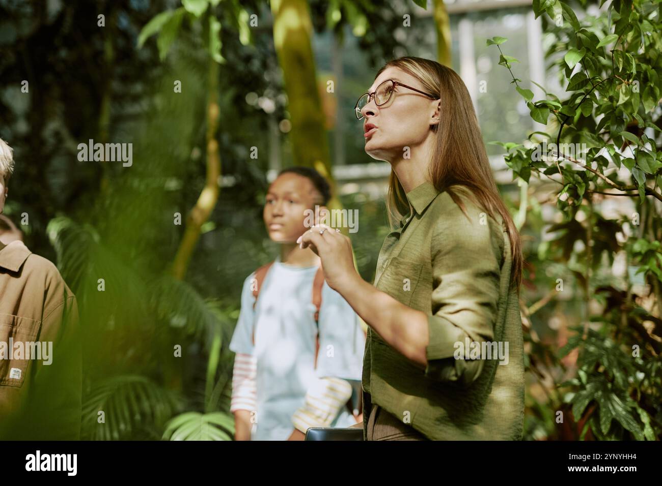 Tour Guide Speaking About Plants Growing In Greenhouse Stock Photo - Alamy