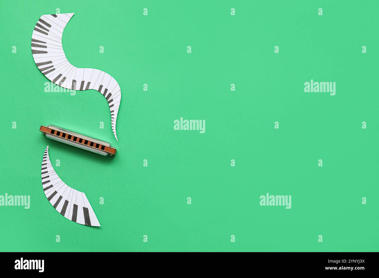 Harmonica and paper piano keys on color background Stock Photo - Alamy