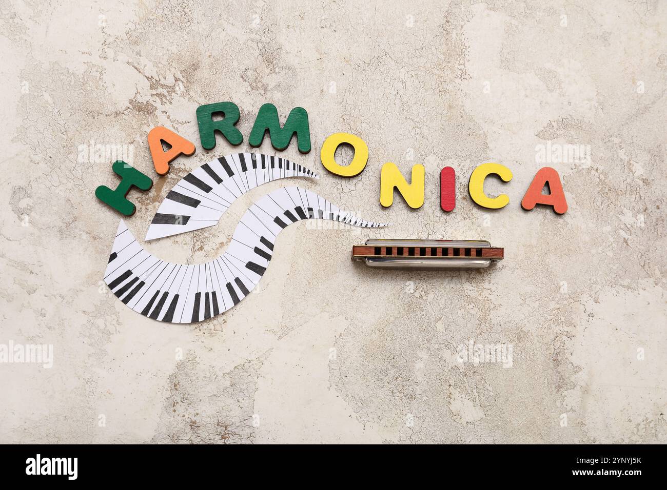 Word HARMONICA made of colorful letters, musical instrument and paper ...