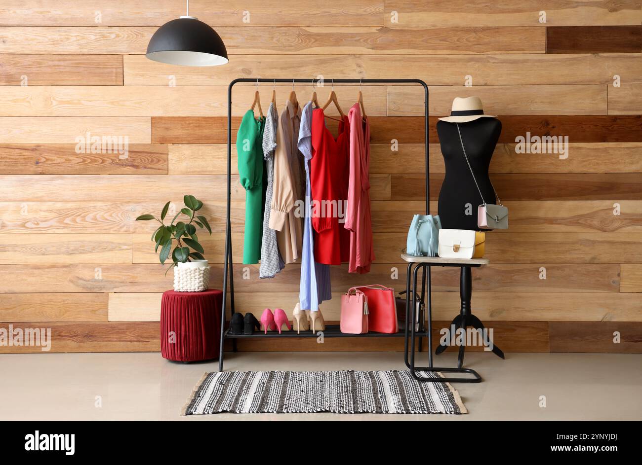 Interior of dressing room with mannequin, clothes rack and table Stock ...