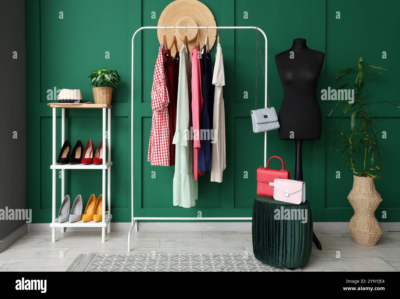 Interior of dressing room with mannequin, clothes rack and shelf unit ...