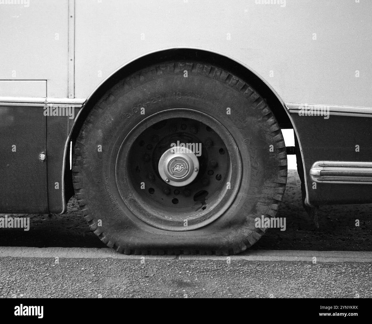 A flat tyre on a tourist coach due to a puncture, 1950s Stock Photo - Alamy