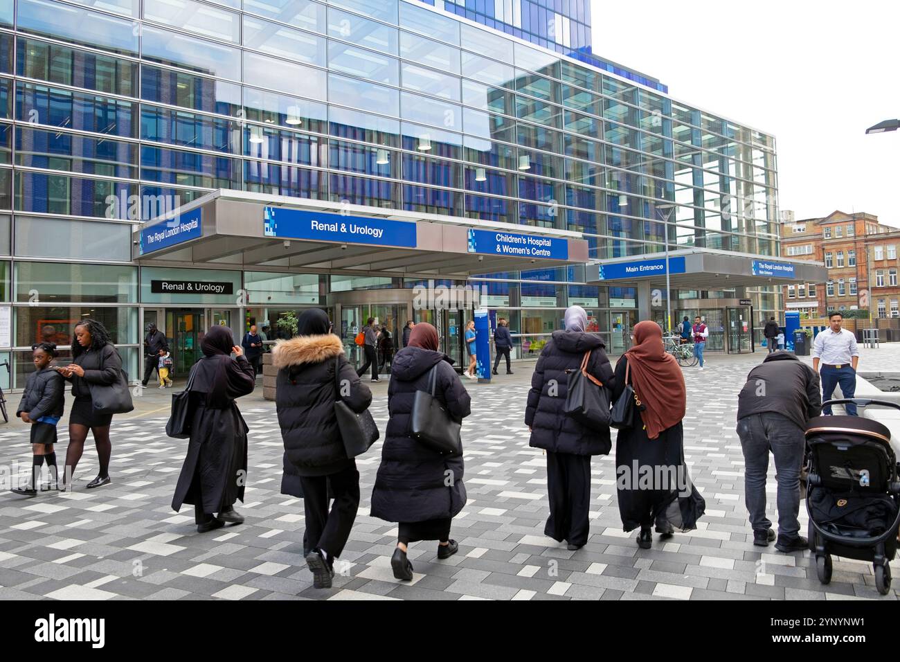 Rear back view of women people walking outside Royal London Hospital in ...