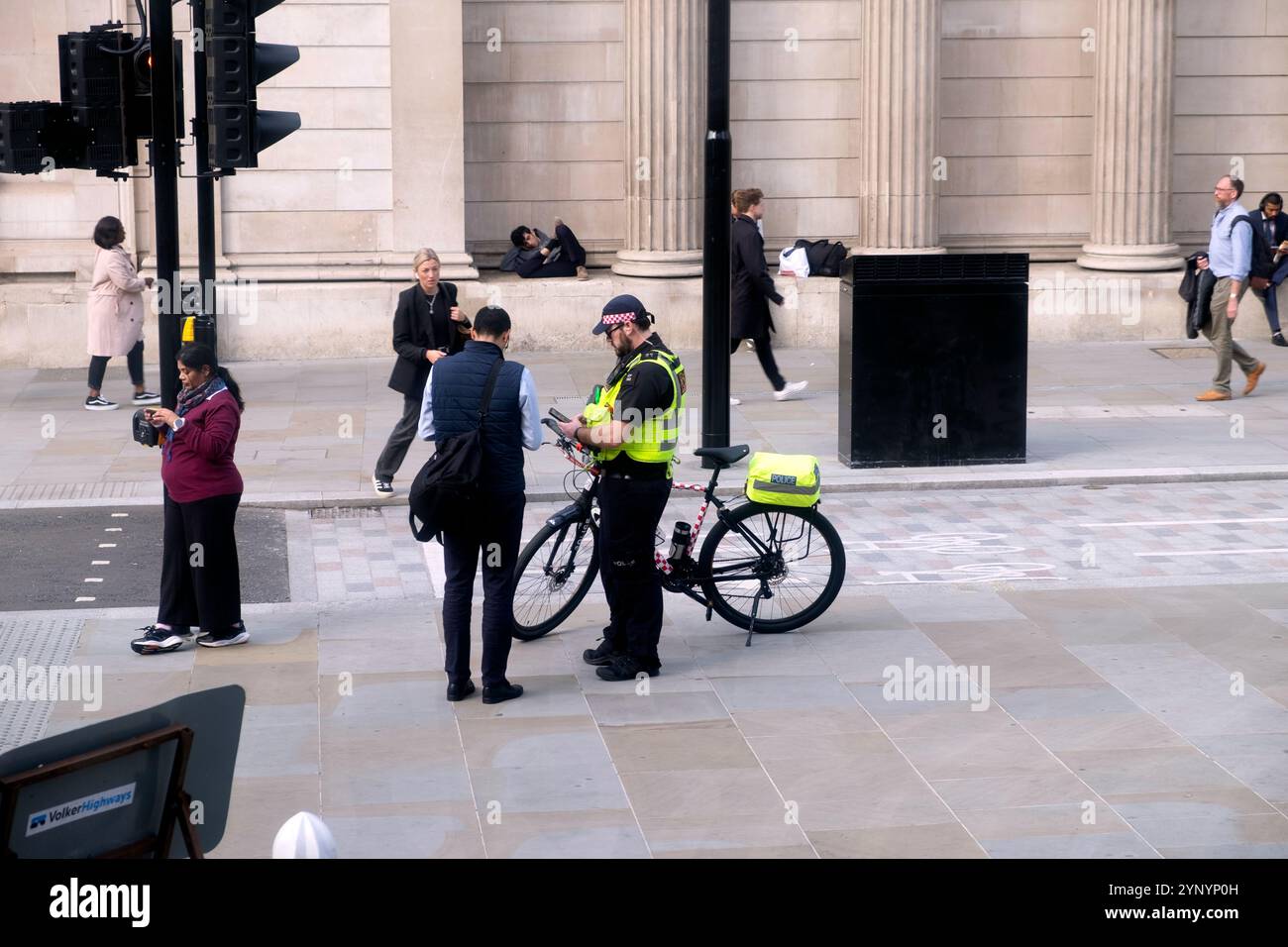 A Metropolitan police Community Support Officer using a mobile phone to ...