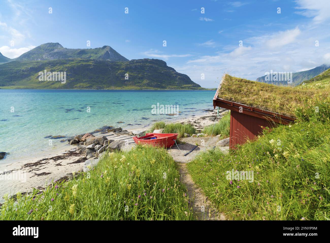 Red rowing boat at a beautiful blue fjord on the Lofoten islands in ...