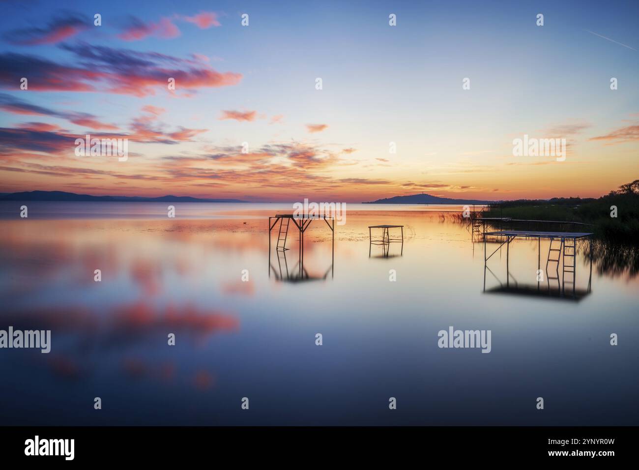 Colorful sunrise with nice reflection in the water at Lake Balaton ...