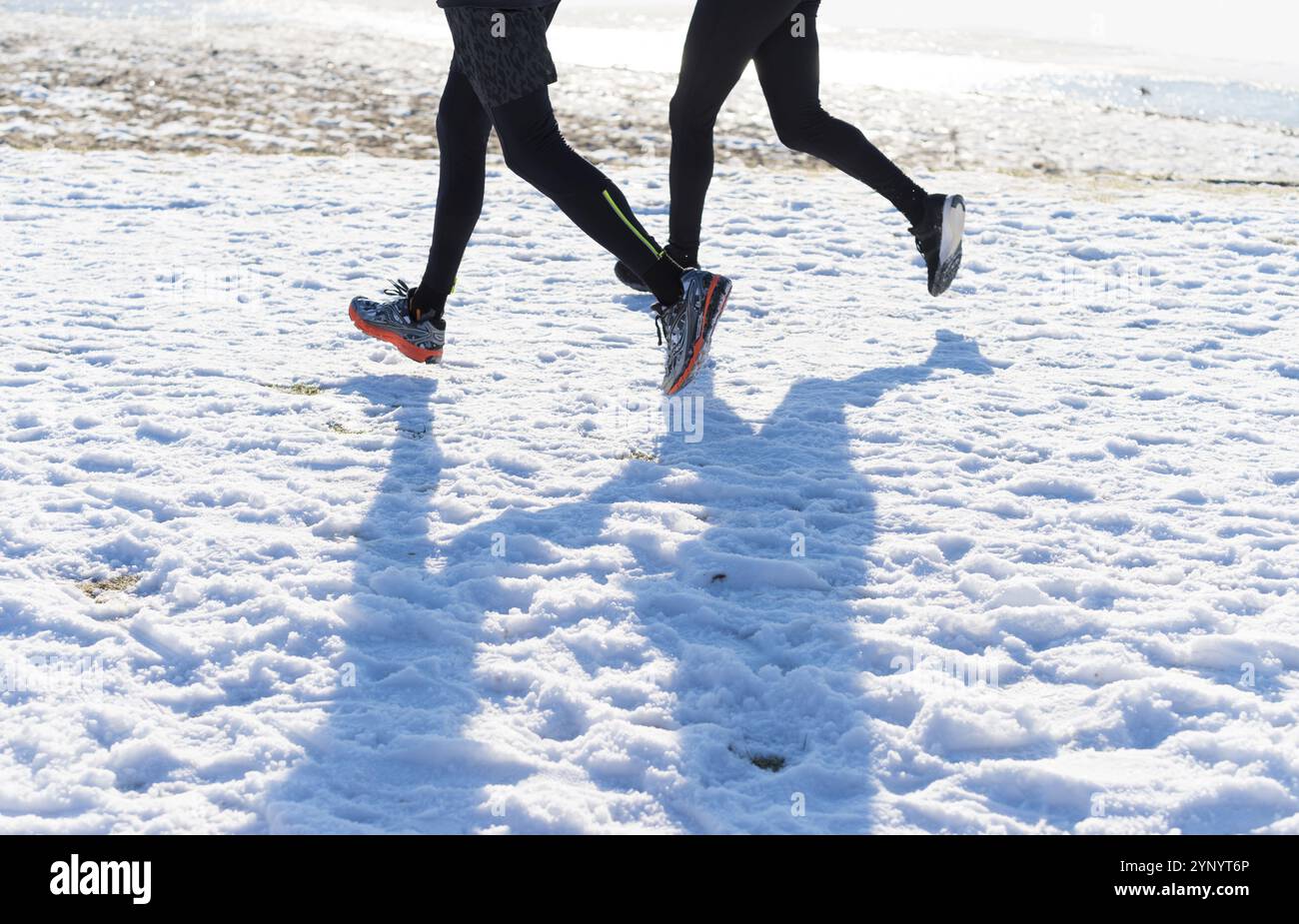 Two pair of legs of some runners in a snow white landscape Stock Photo ...
