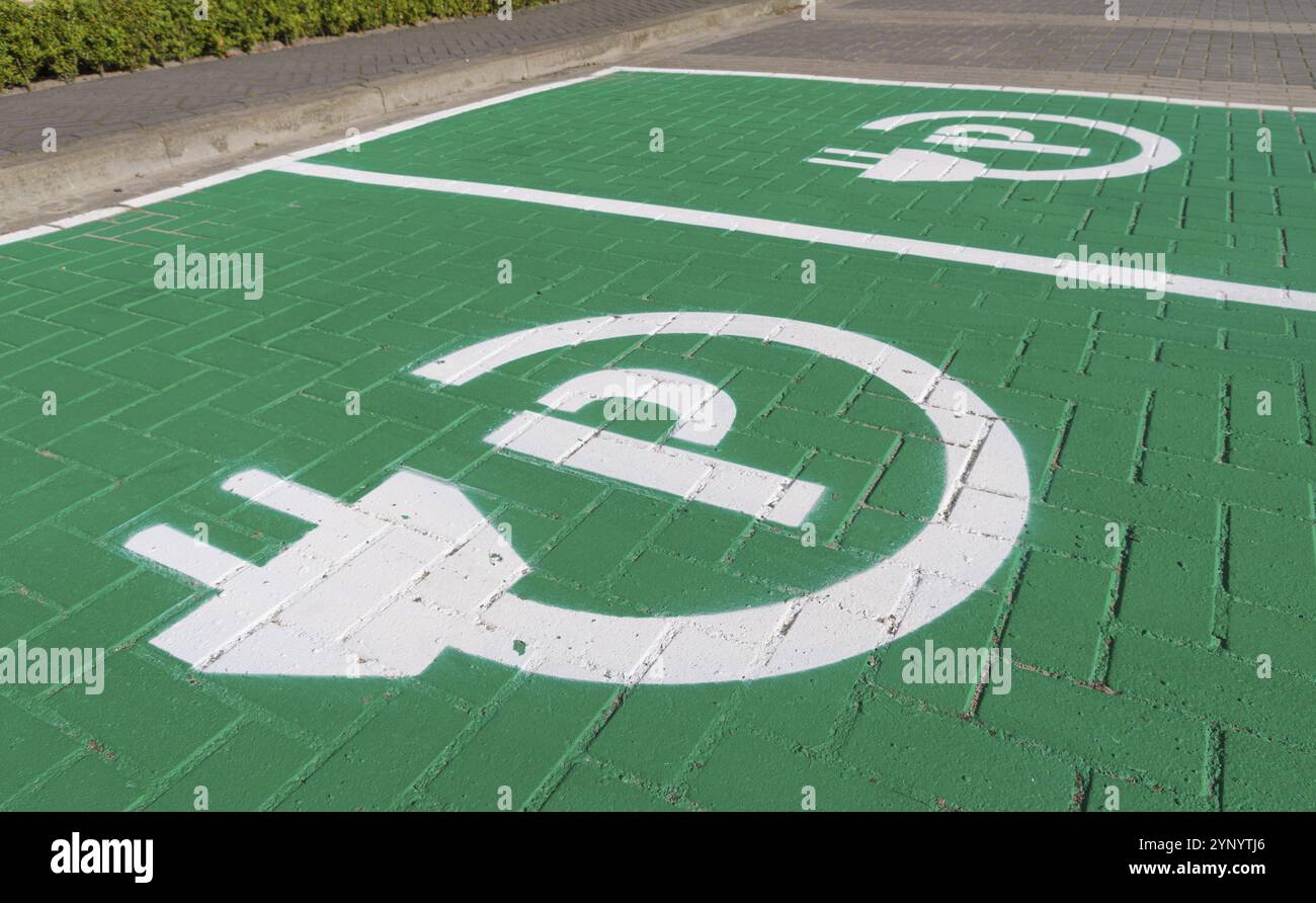 Parking place with charging symbol for electric cars Stock Photo - Alamy