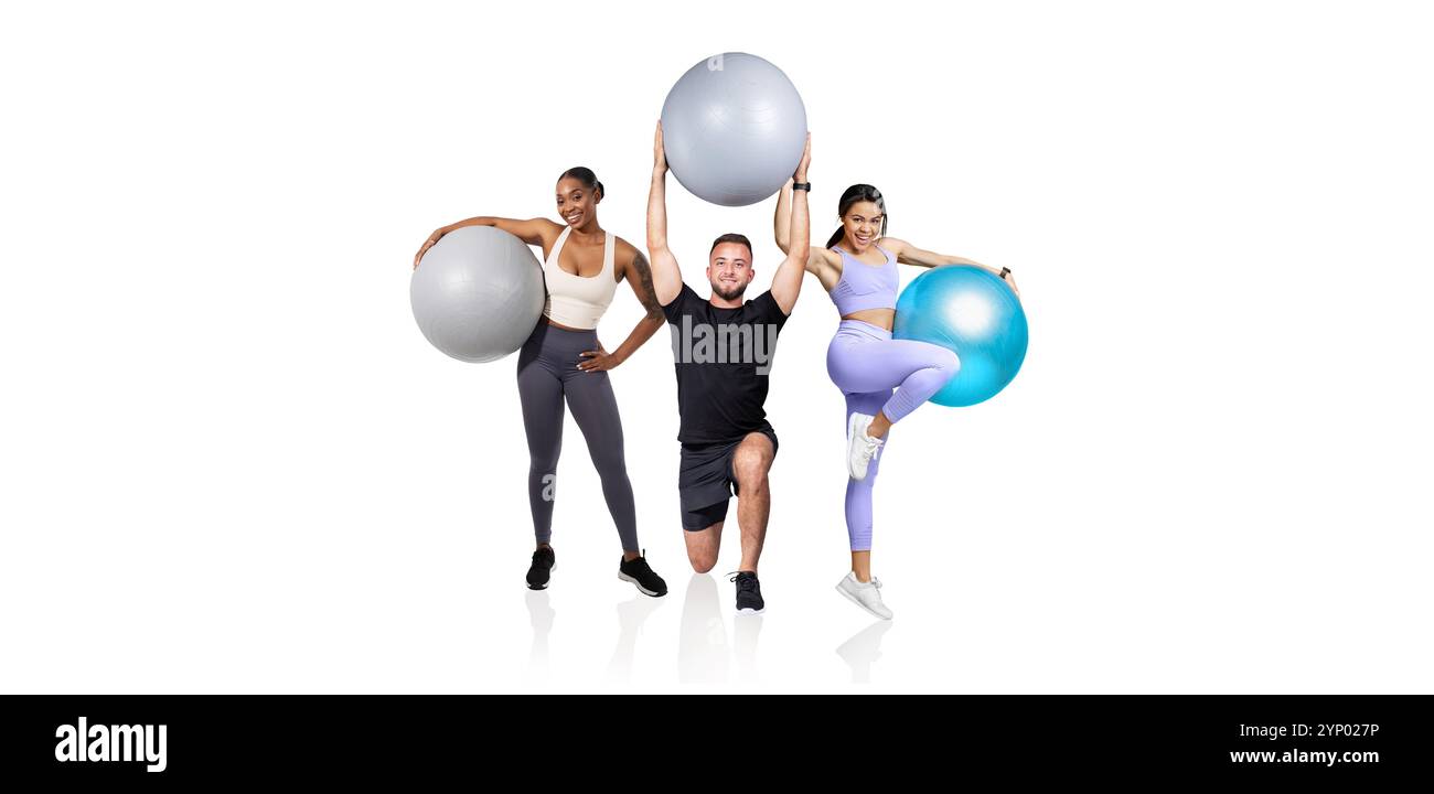 Three fitness enthusiasts pose with exercise balls in a bright studio ...