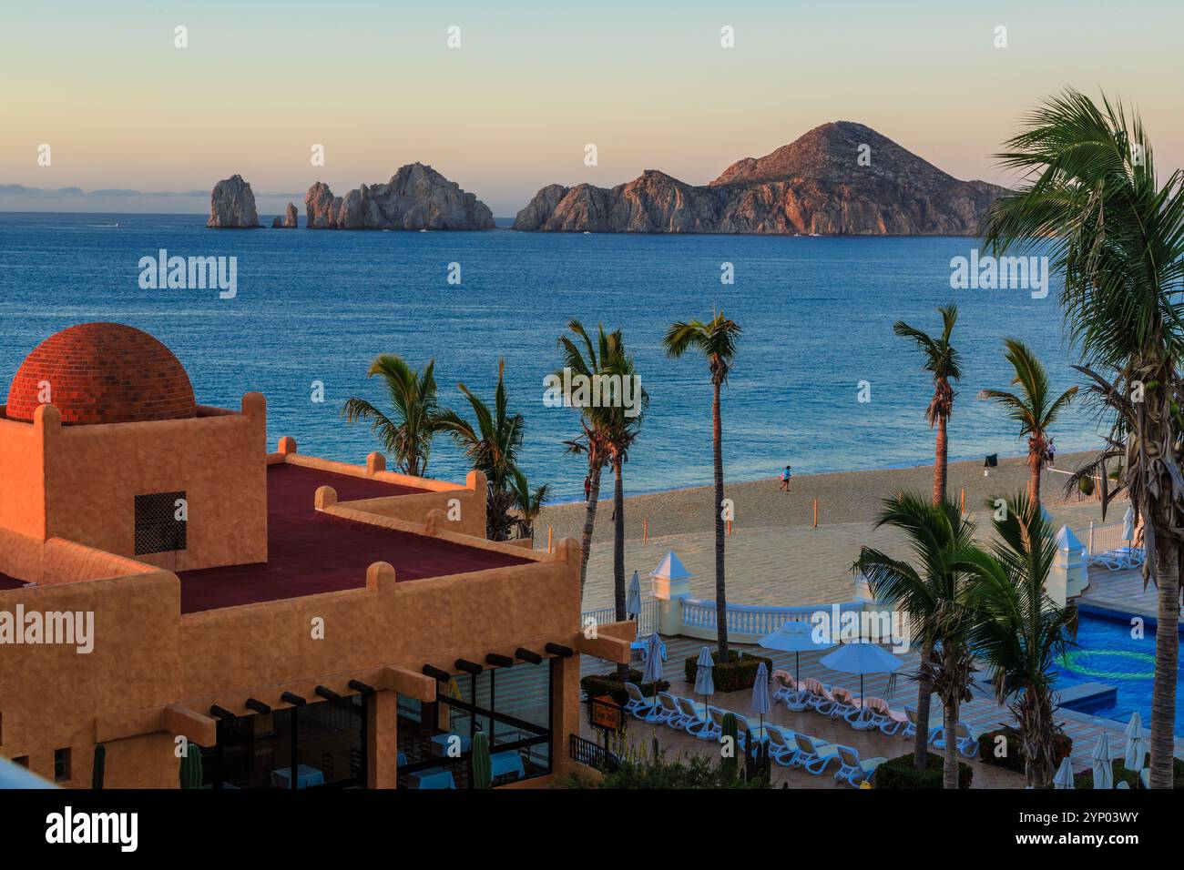 A beach resort with a view of the ocean and mountains. The resort is ...