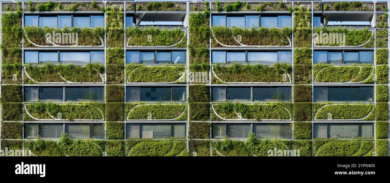 Living green wall facade of a modern building with a mix of glass ...