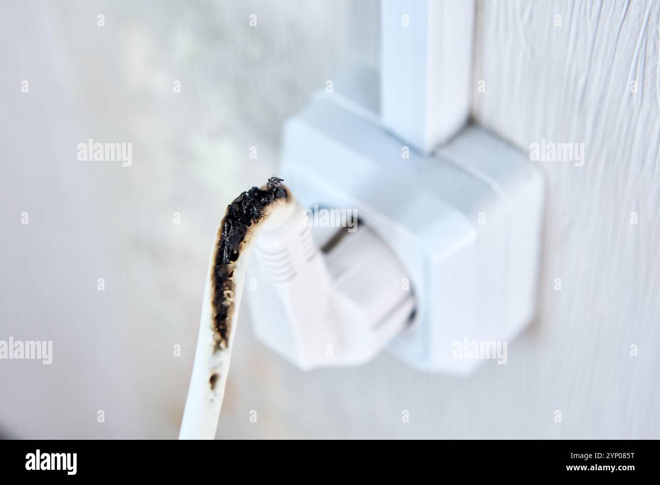 Burnt extension cord with plug still connected to outlet Stock Photo ...