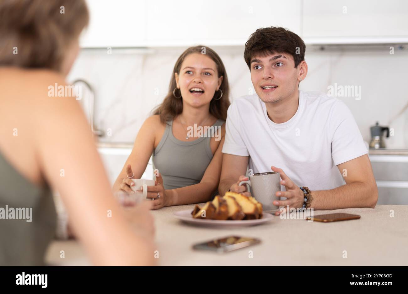 Young girl and guy have nice conversation with woman Stock Photo - Alamy