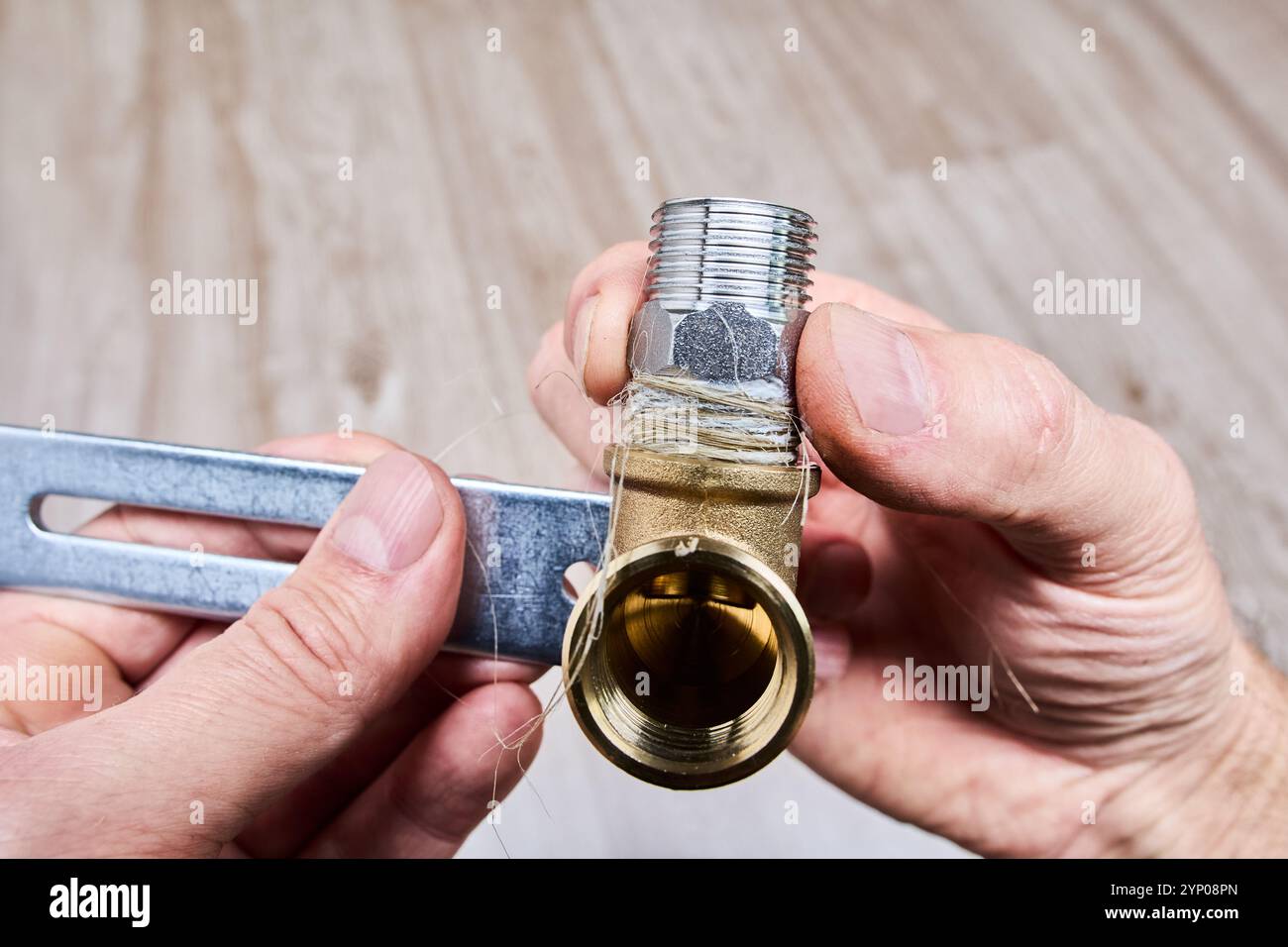 Plumbing hemp with sealing paste seals threaded connection on hexagonal ...