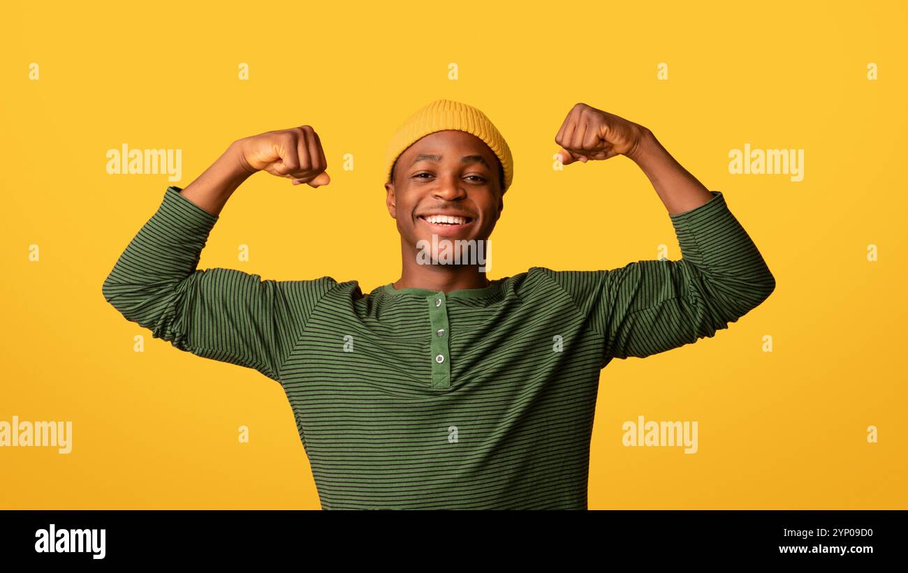 Strong Black Hipster Guy In Orange Hat Showing Biceps Muscles At Camera ...