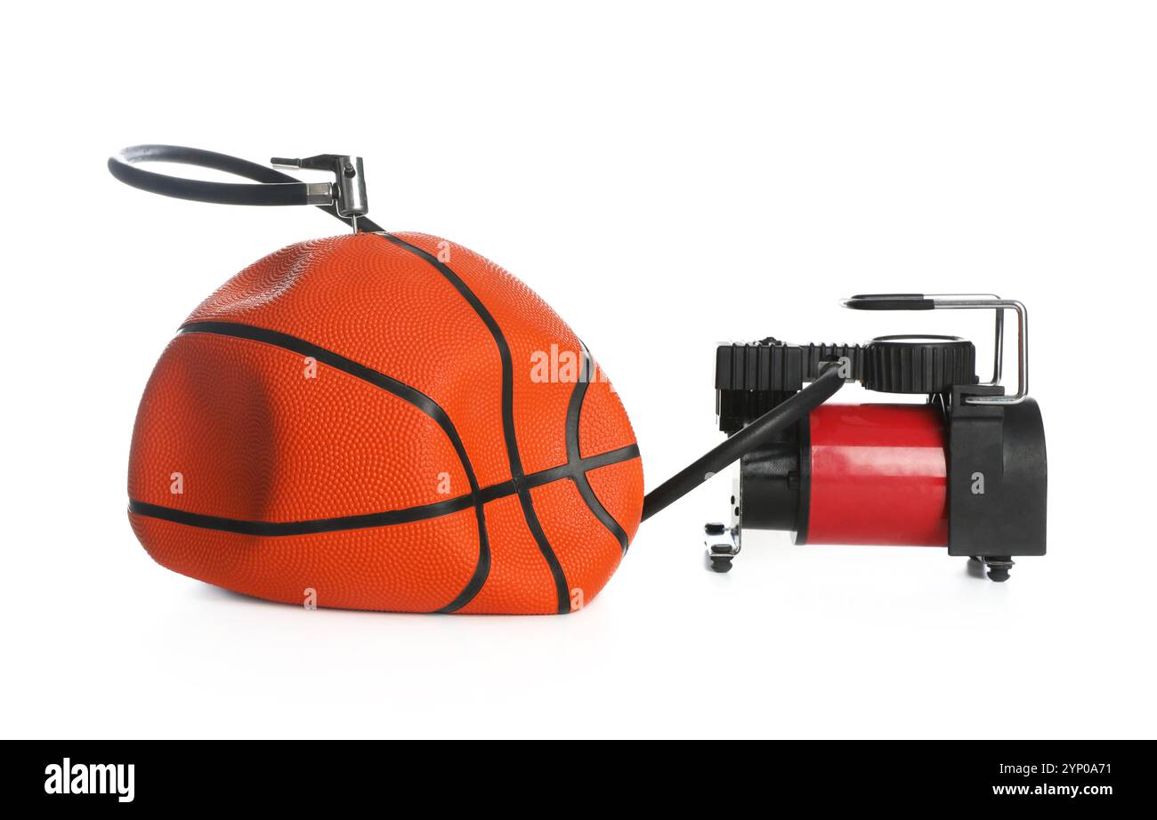 Deflated basketball ball and air compressor isolated on white Stock ...